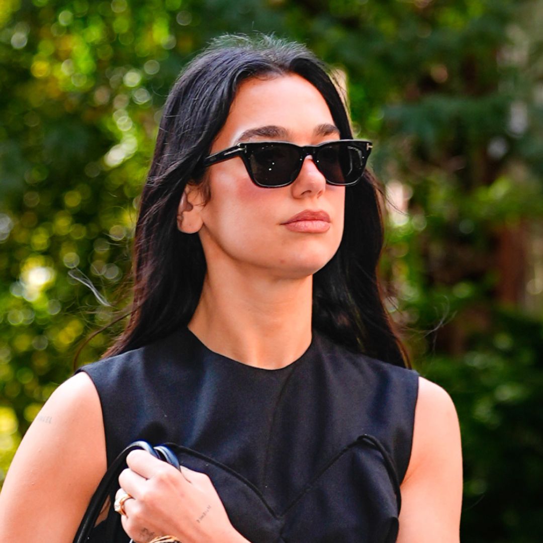 Dua Lipa parties in a $586 little black mini dress and a golden crown
