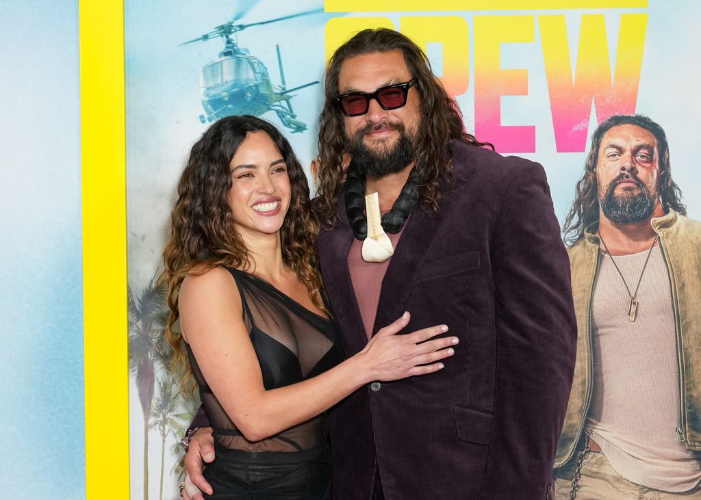 Jason Momoa and girlfriend Adria Arjona pack on the PDA on red carpet