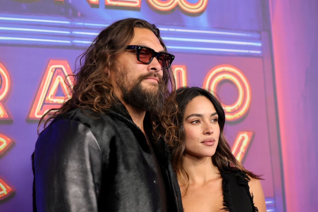 Jason Momoa and girlfriend Adria Arjona pack on the PDA on red carpet