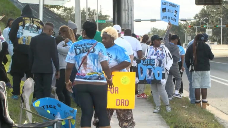 Crowds line Archer Road calling for answers in death investigation ...