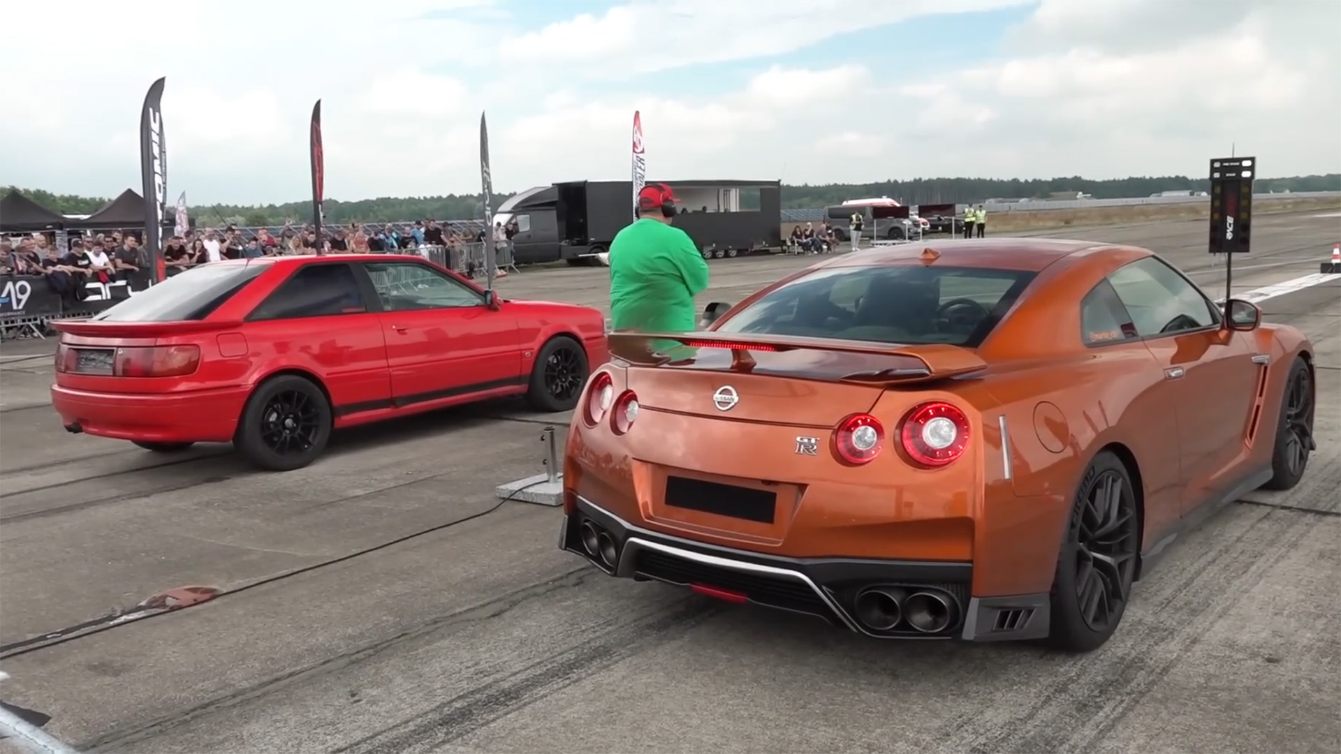 Modified sports cars compete in high-speed drag races
