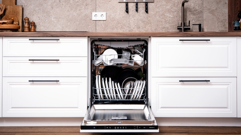 Use a creative curtain trick to cover the eyesore of an ugly dishwasher
