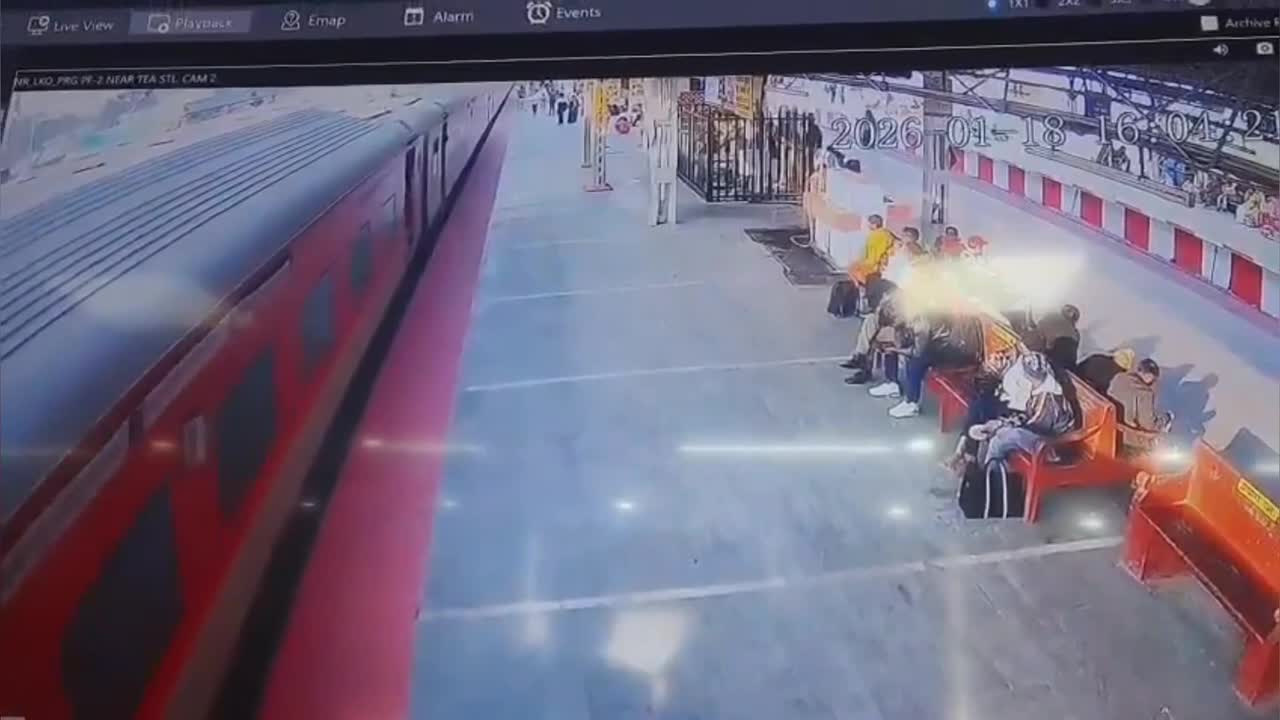 Father carrying child dragged by train before station guards save them
