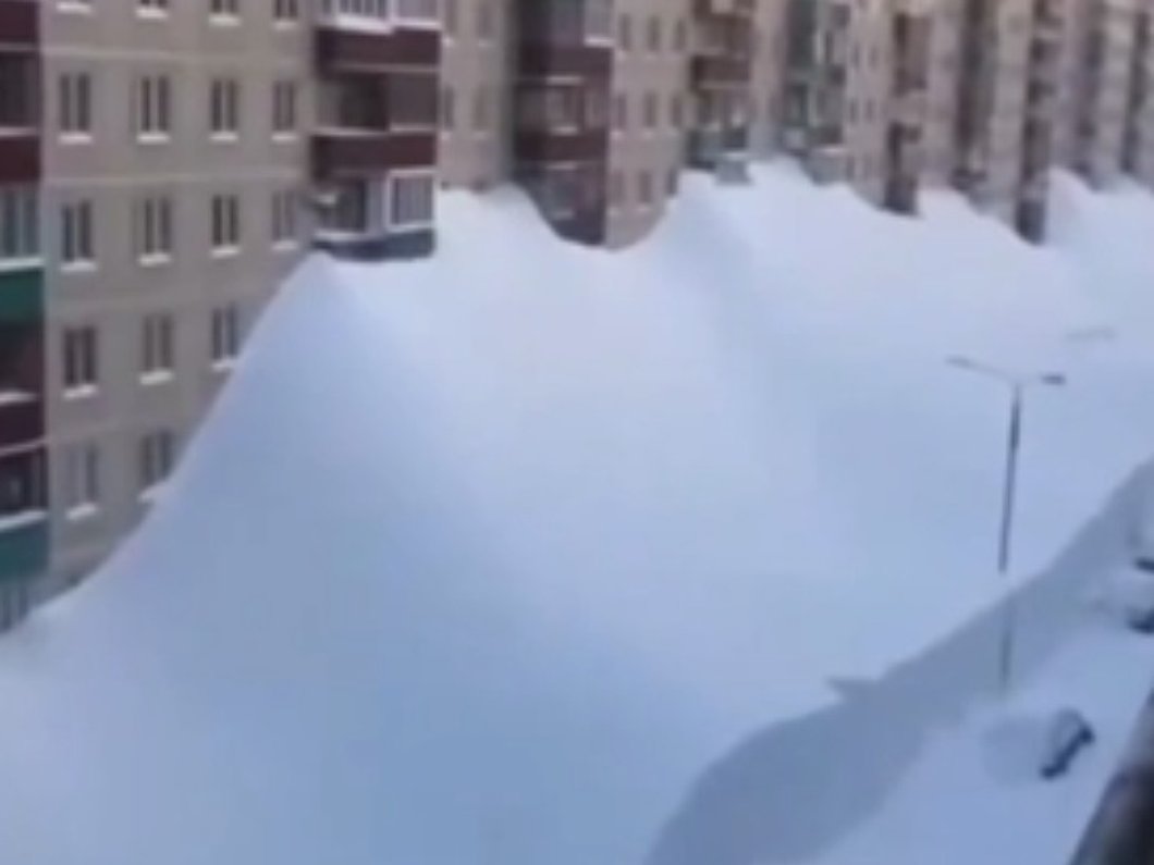 Up to the ninth floor: Entire cities buried under masses of snow