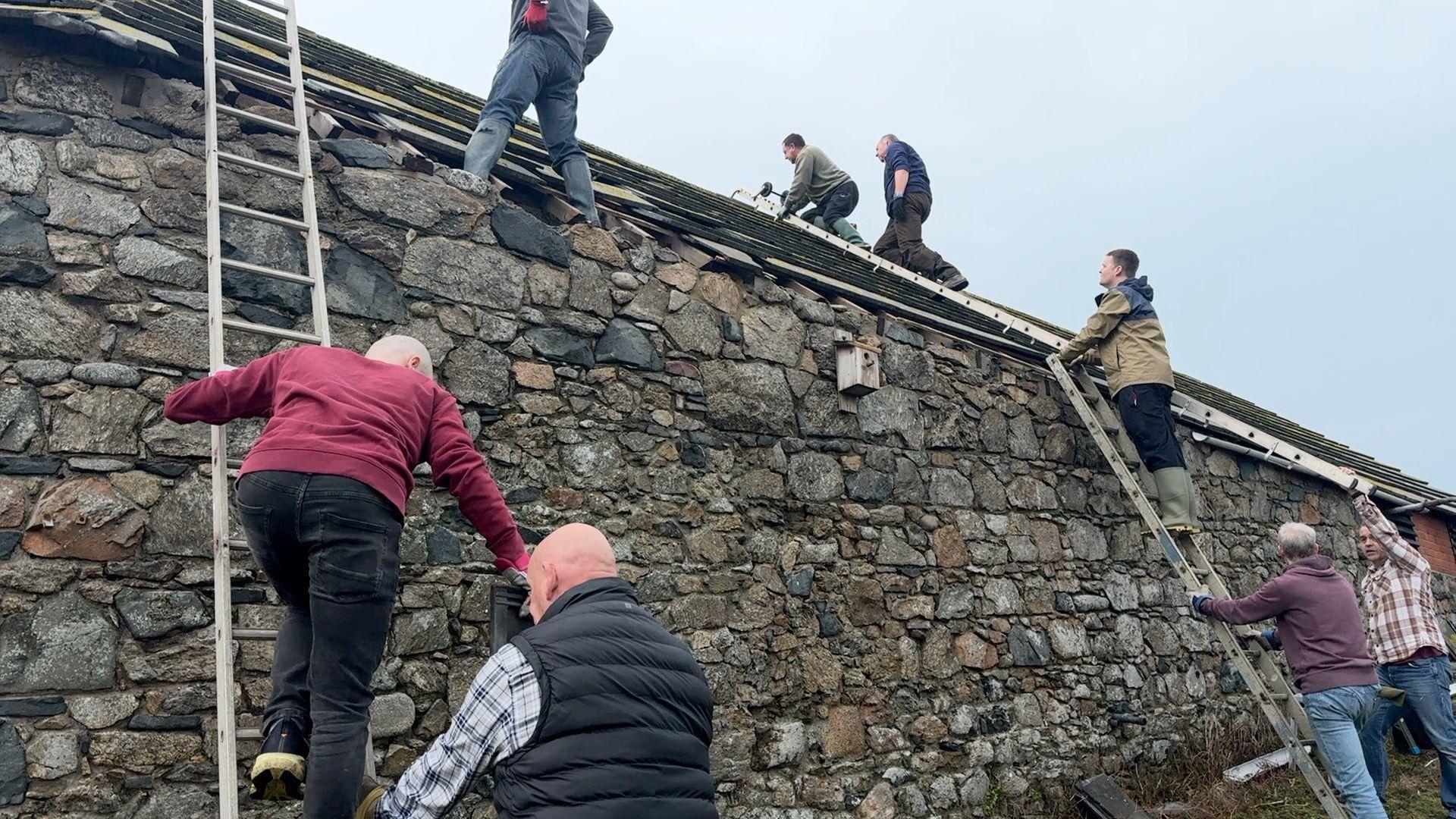 Volunteers repair storm-damaged house on island