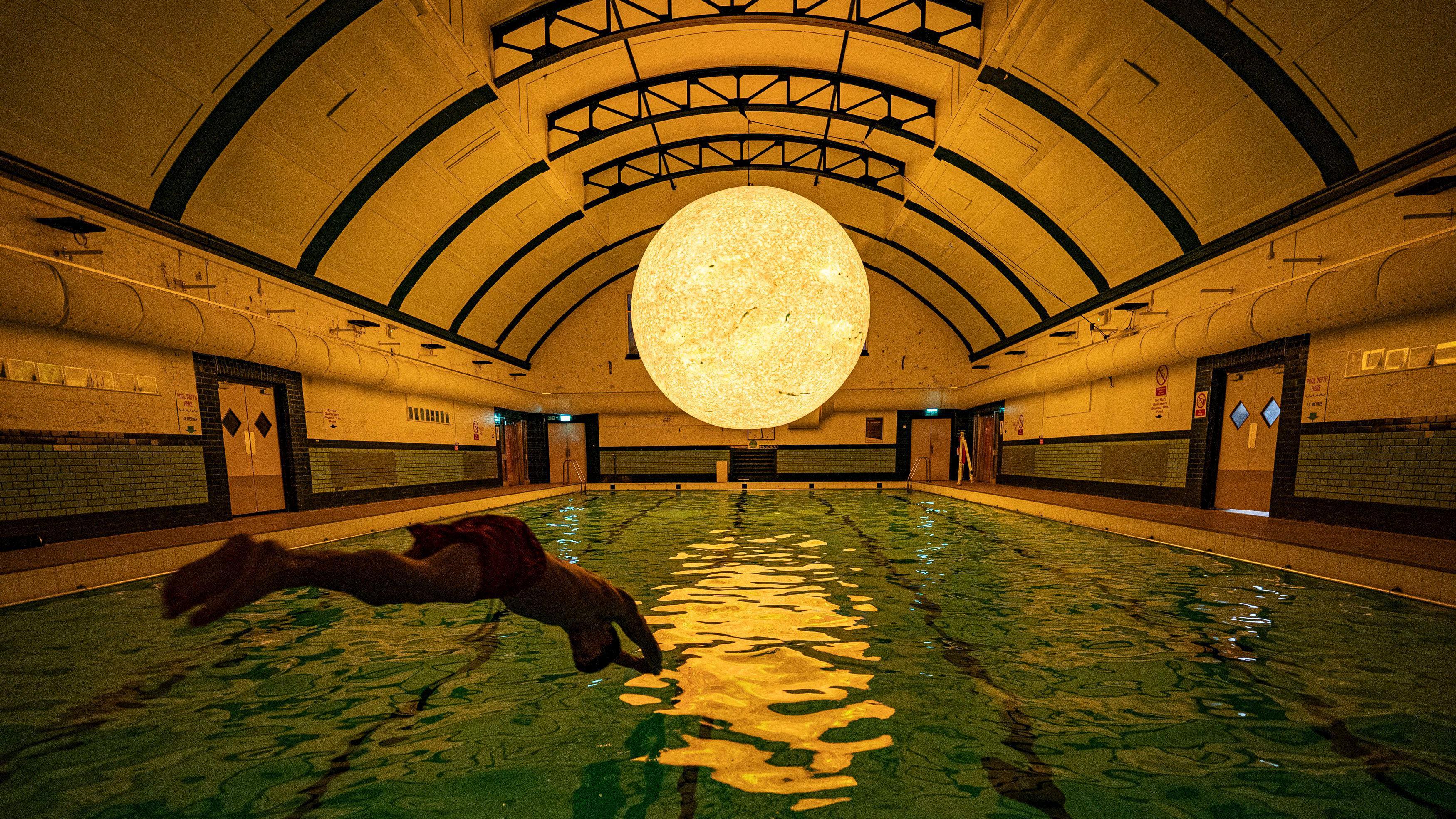 Sun-inspired sculpture on display at swimming pool