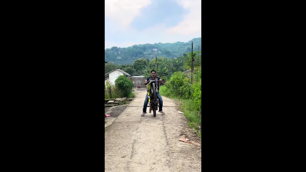 Rider practicing wheelie stunt lose control of motorcycle and ...