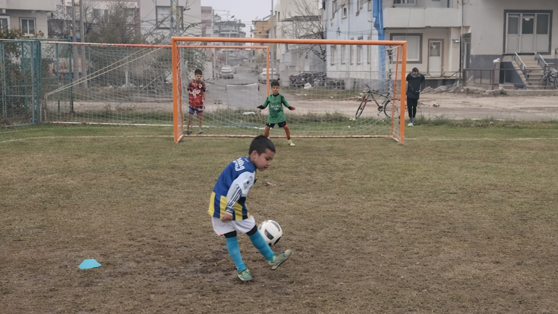 This boy takes a penalty without looking