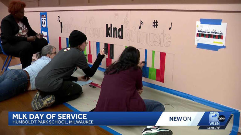Milwaukee volunteers paint murals at school on MLK Day