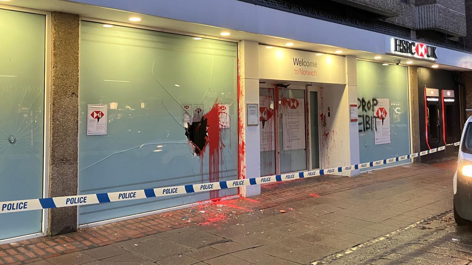Bank vandalised with red paint and window smashed