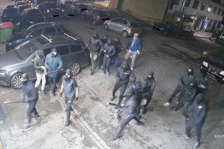 Terrifying moment 17-strong masked mob descend on garage before 'large ...