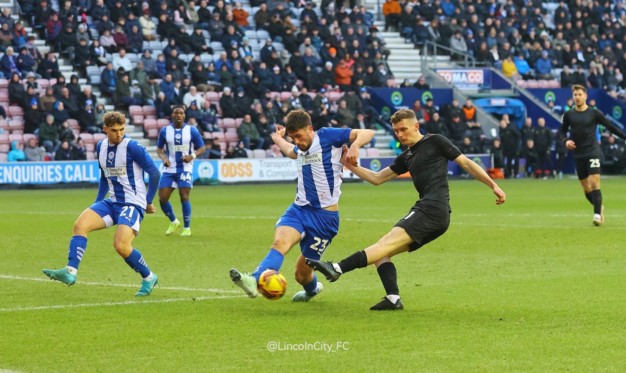 Wigan Athletic locked in battle with League One rivals for defender