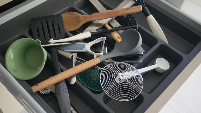 Reusing cardboard makes kitchen utensil organization cheap and simple