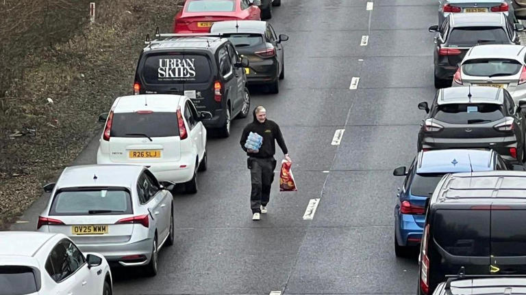 Man hands out food to people stuck in traffic