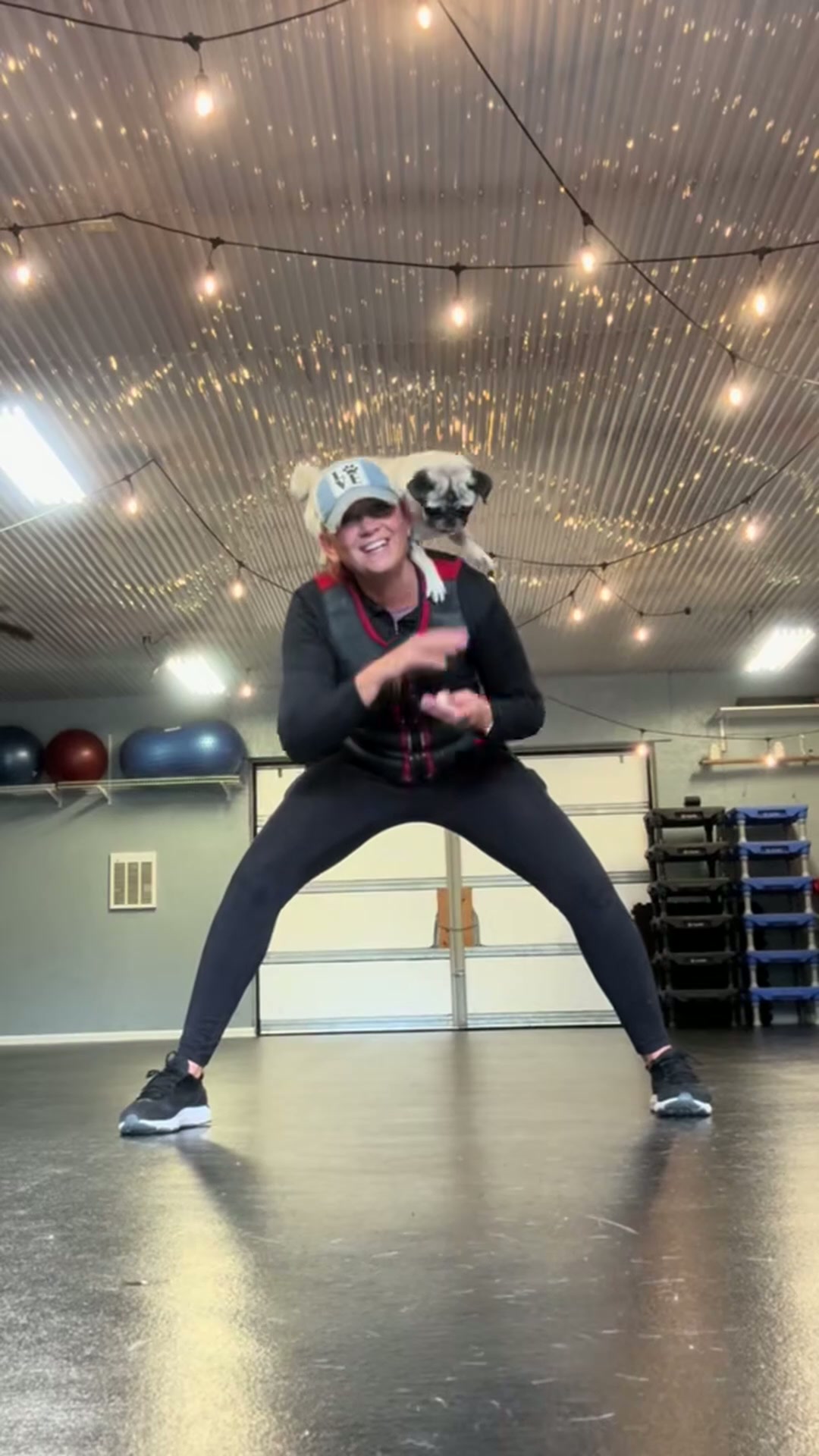 Woman practices energetic dance moves with playful dog
