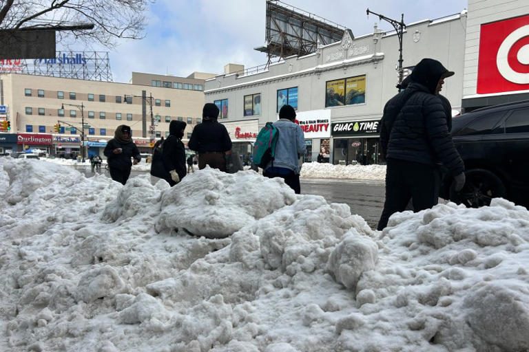 Climbing bus stop mountain: Snowfall makes a mess of wheeled commutes