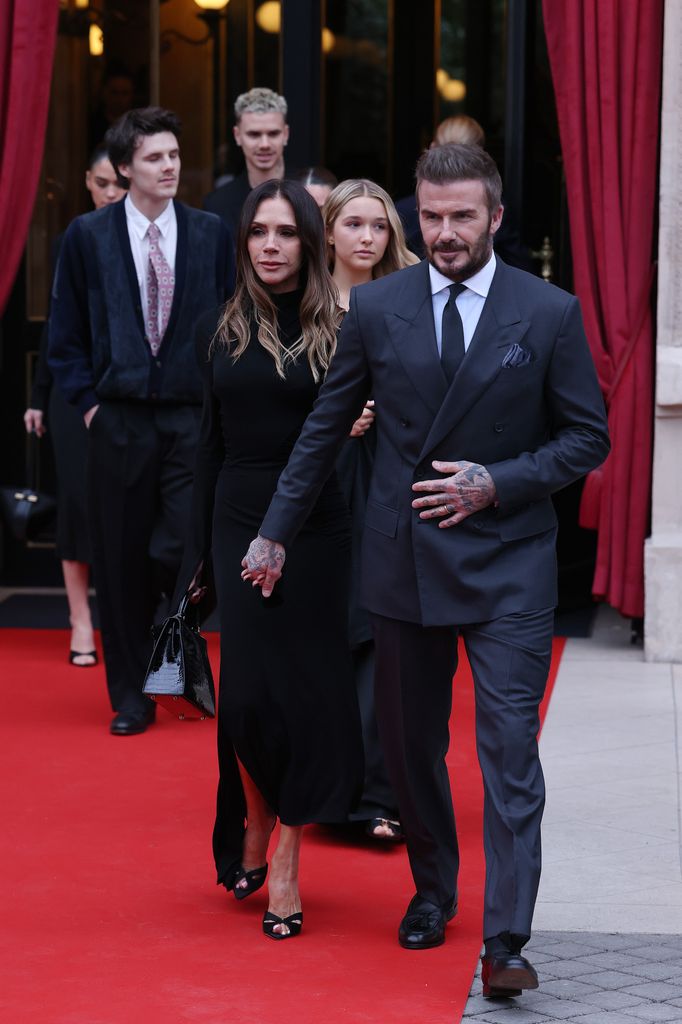 Defiant Victoria Beckham supported by family as she receives top honour ...