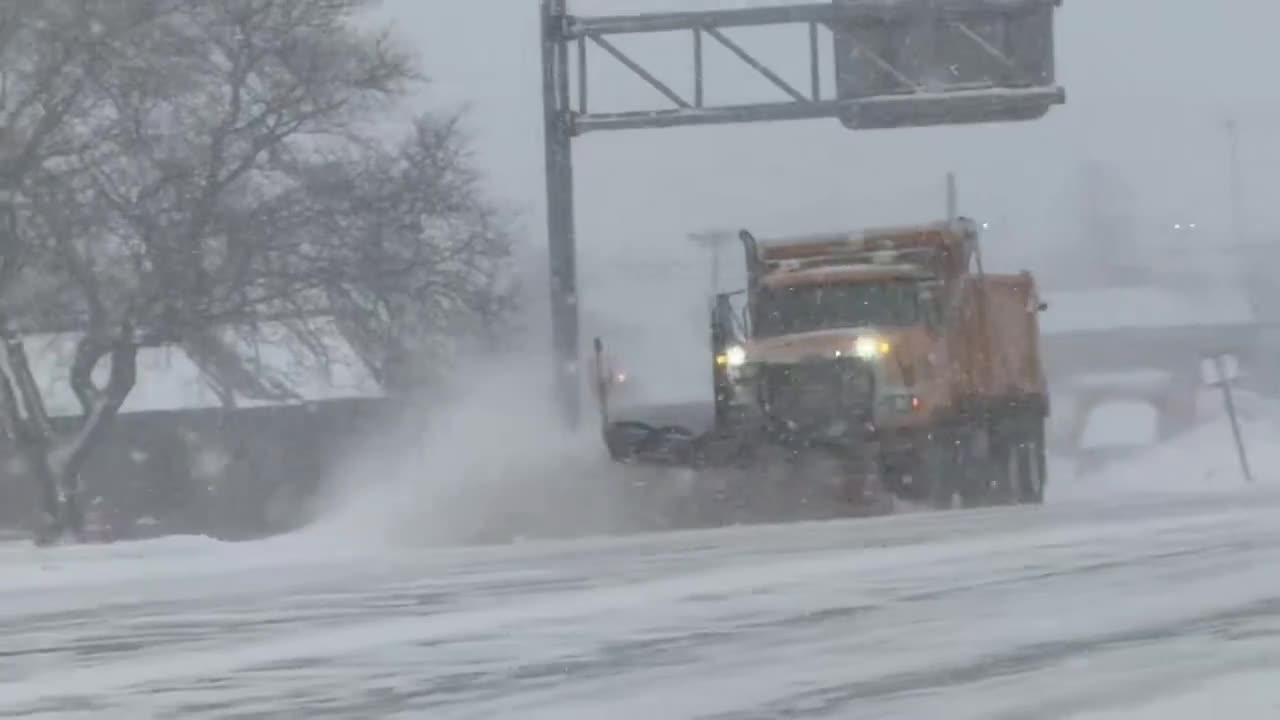 Snowplows clear roads during winter storm in Buffalo, New York, USA