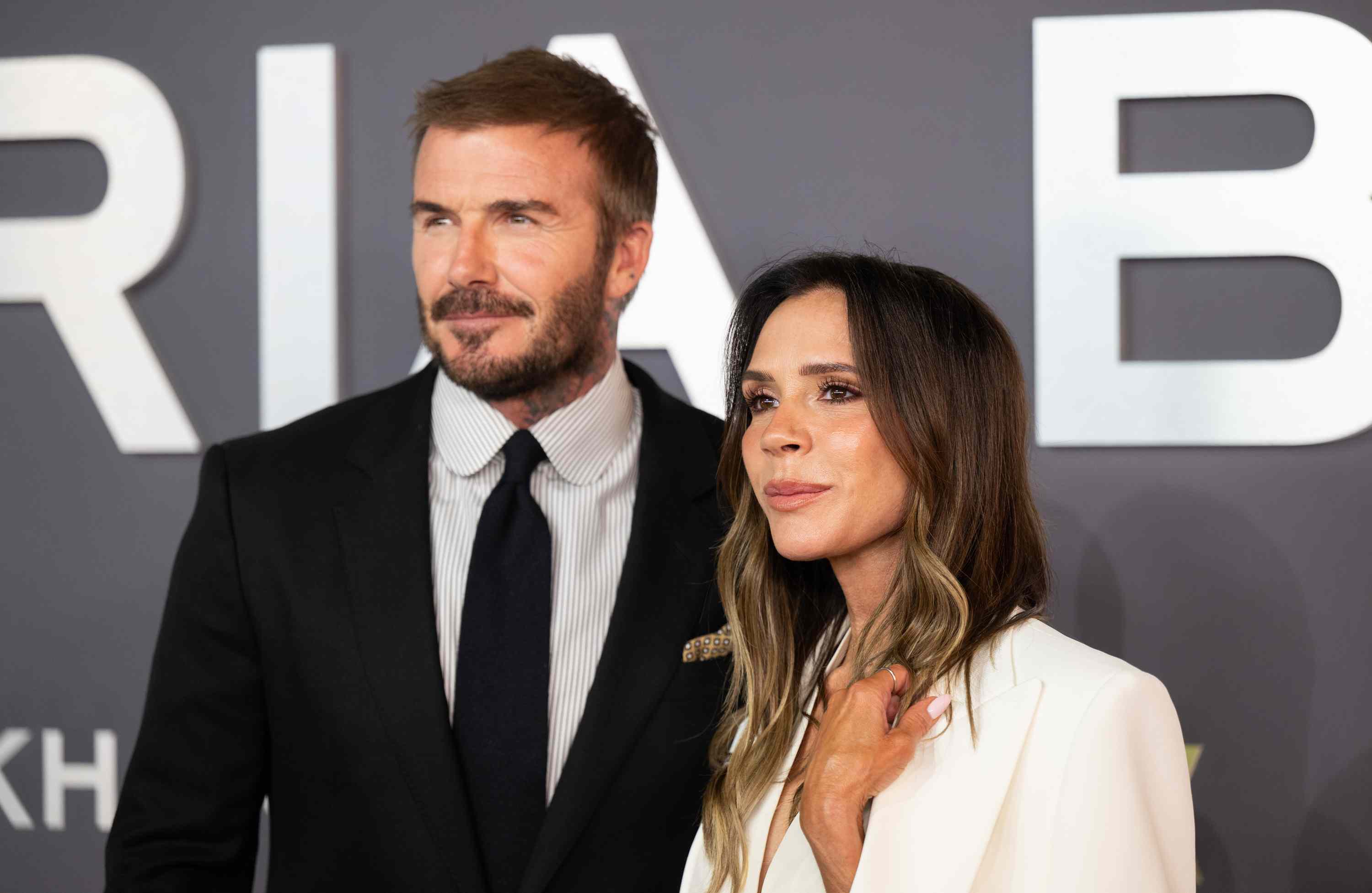 Victoria Beckham rocks thigh-high slit LBD for outing with David and ...