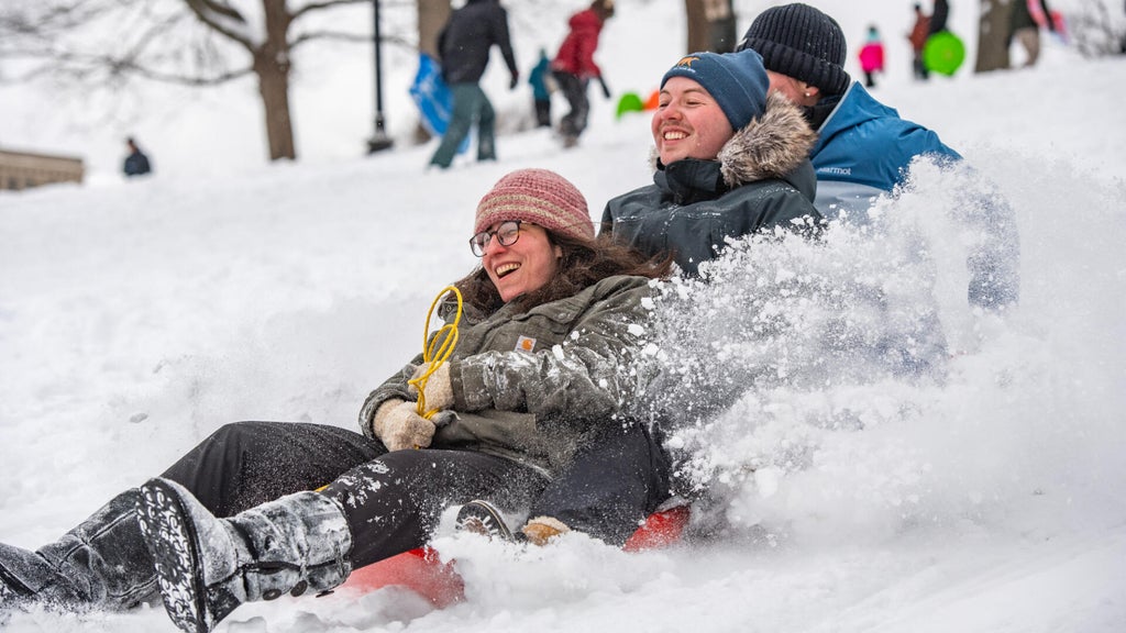 Boston residents enjoy snow day by skiing and sledding on the Common ...