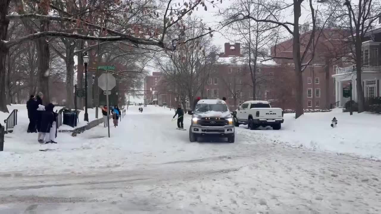 Snowboarder cruises across snow-covered road in Ohio