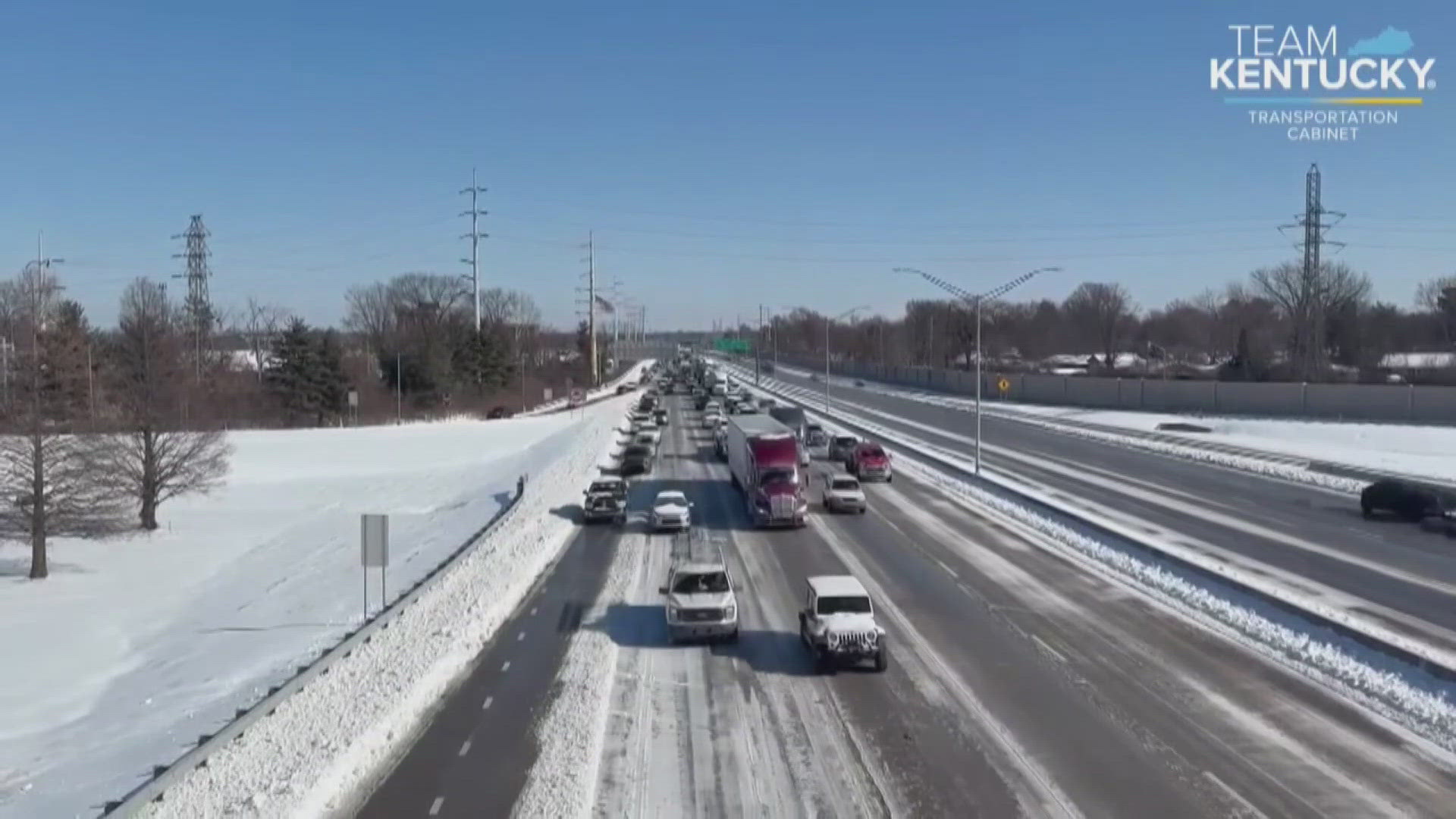 Kentucky snow crews clear roads as drivers warned to stay back