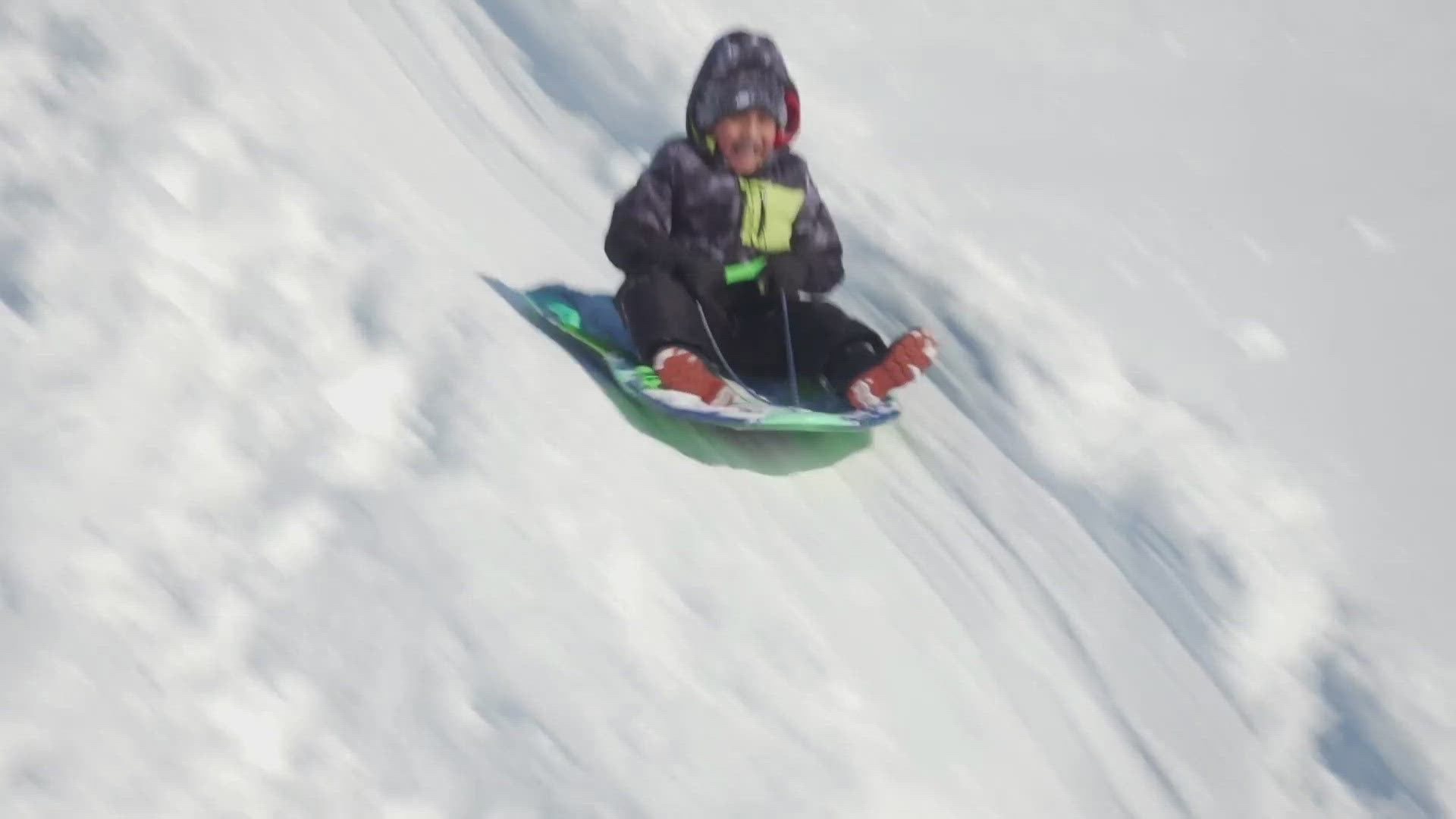 Seymour buried in a foot of snow as kids sled and crews clear roads