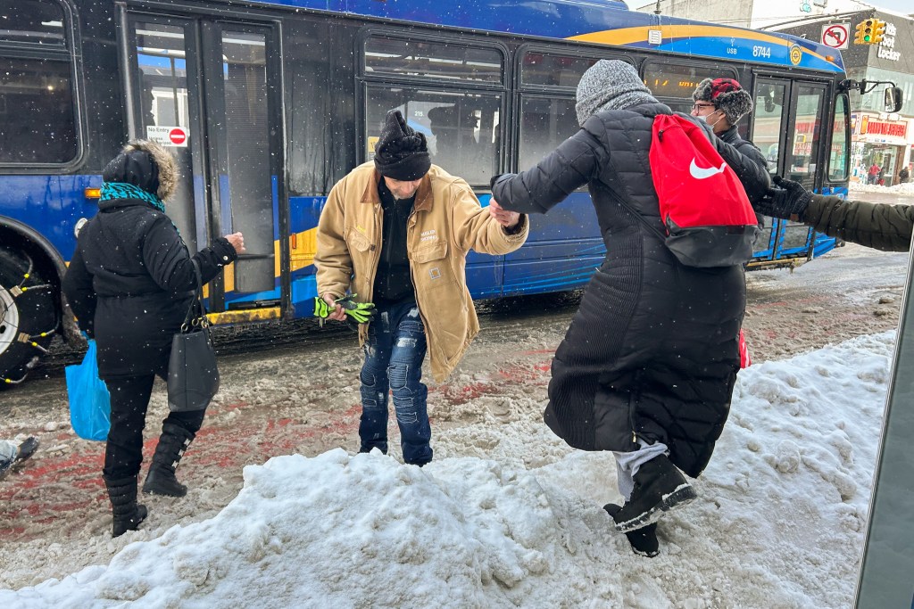 Climbing bus stop mountain: Snowfall makes a mess of wheeled commutes