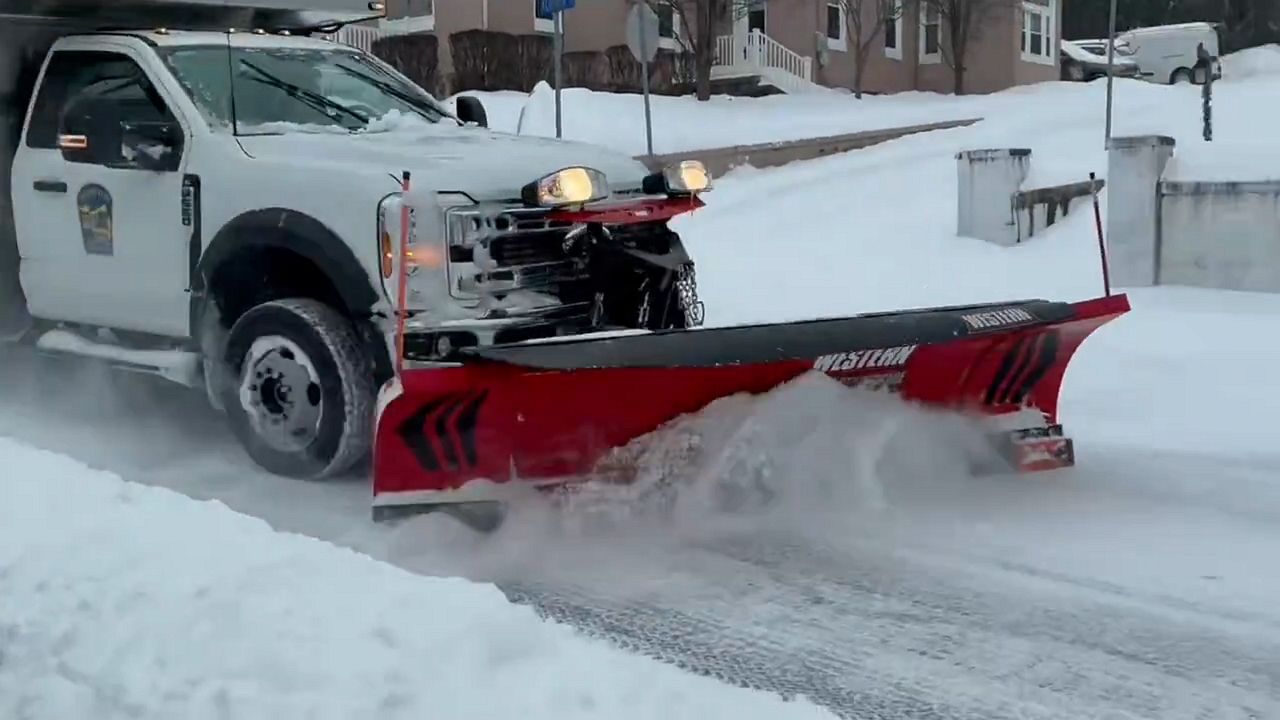 Snowplow clears heavy snow during winter storm in Berks, Pennsylvania, USA