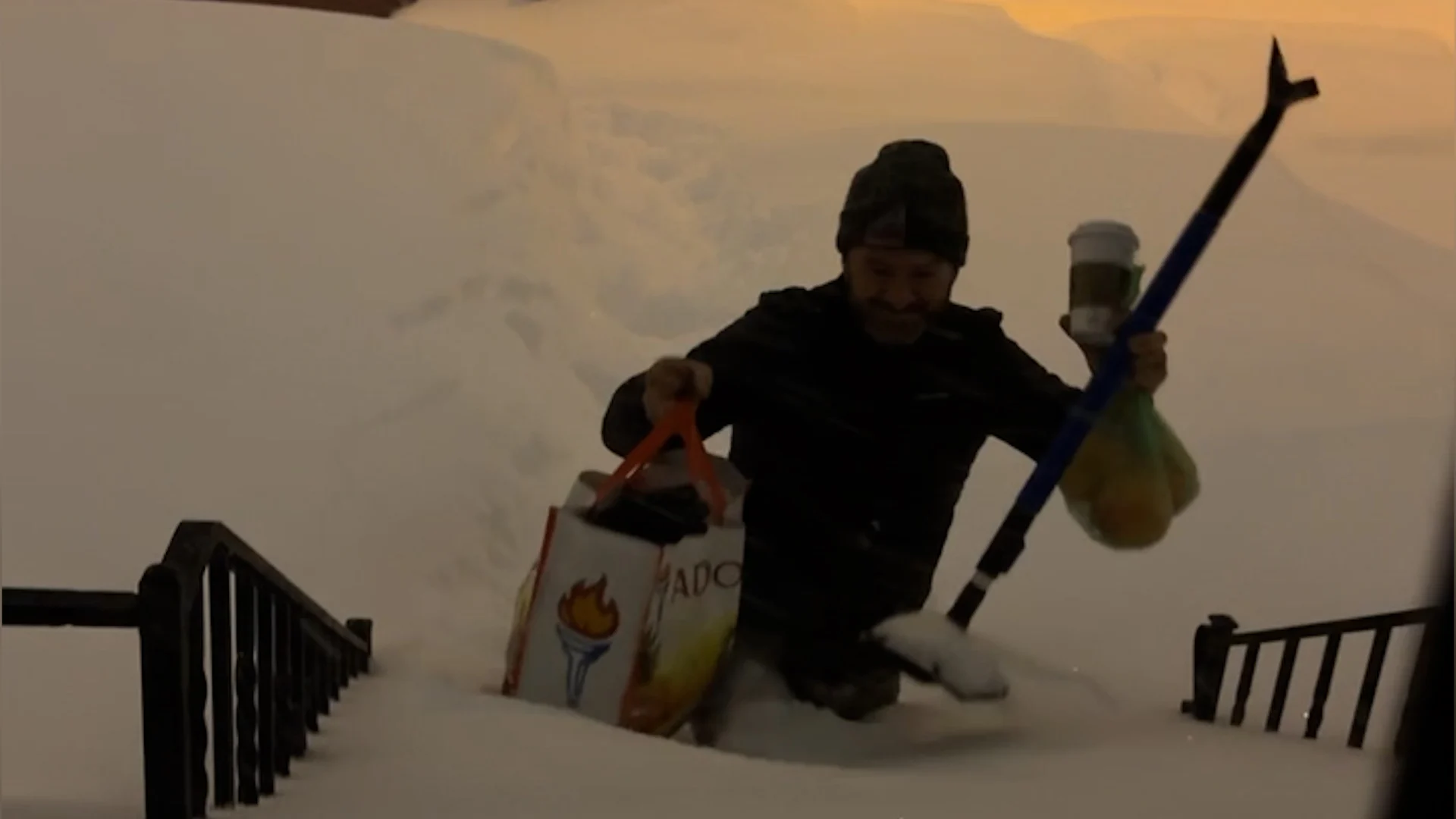 Toronto resident waist-deep in snow after storm batters North America
