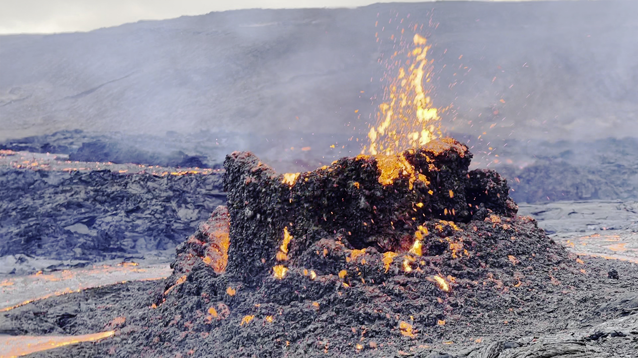 Tourists gather near the Geldingadalir volcano to witness fiery activity