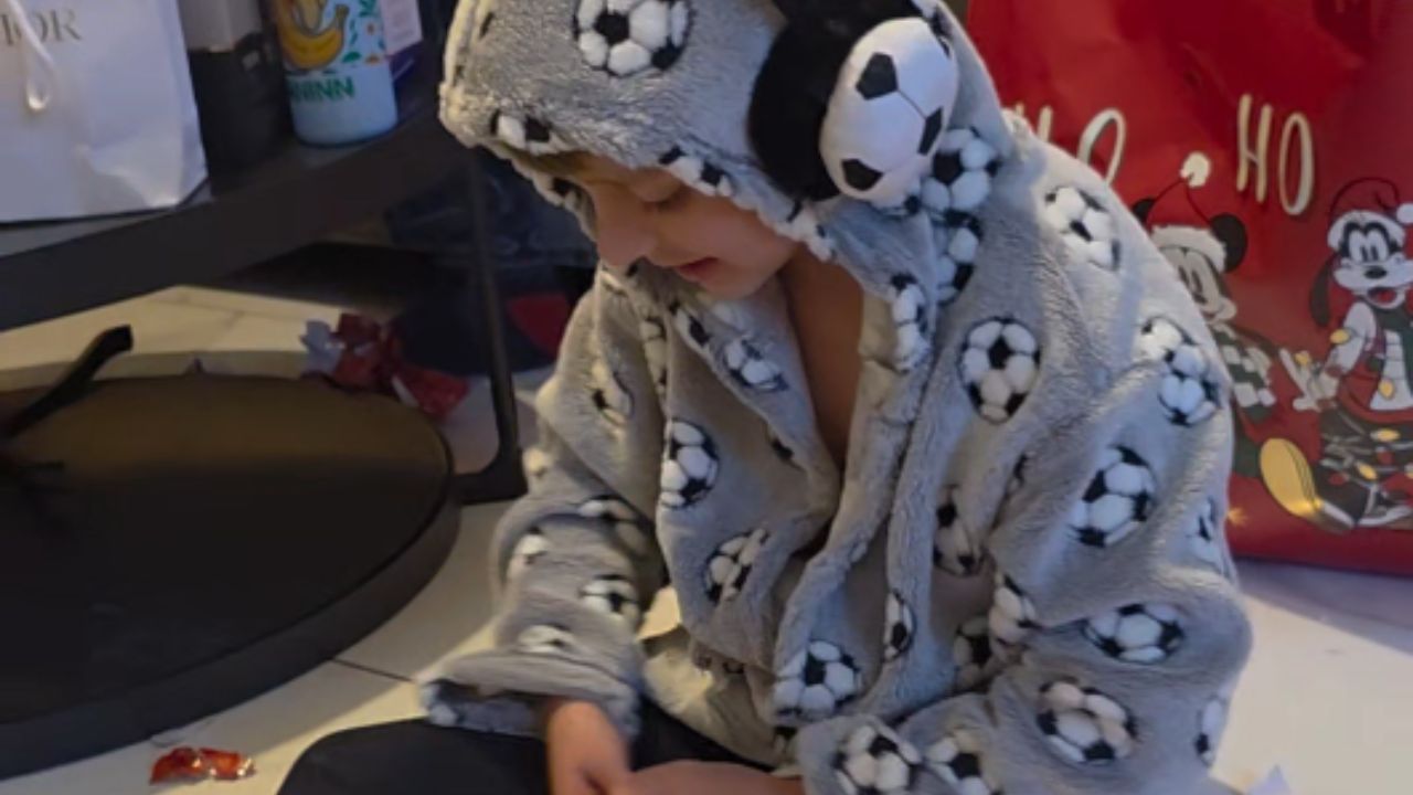 Child tears up after unwrapping a gaming console gift on Christmas