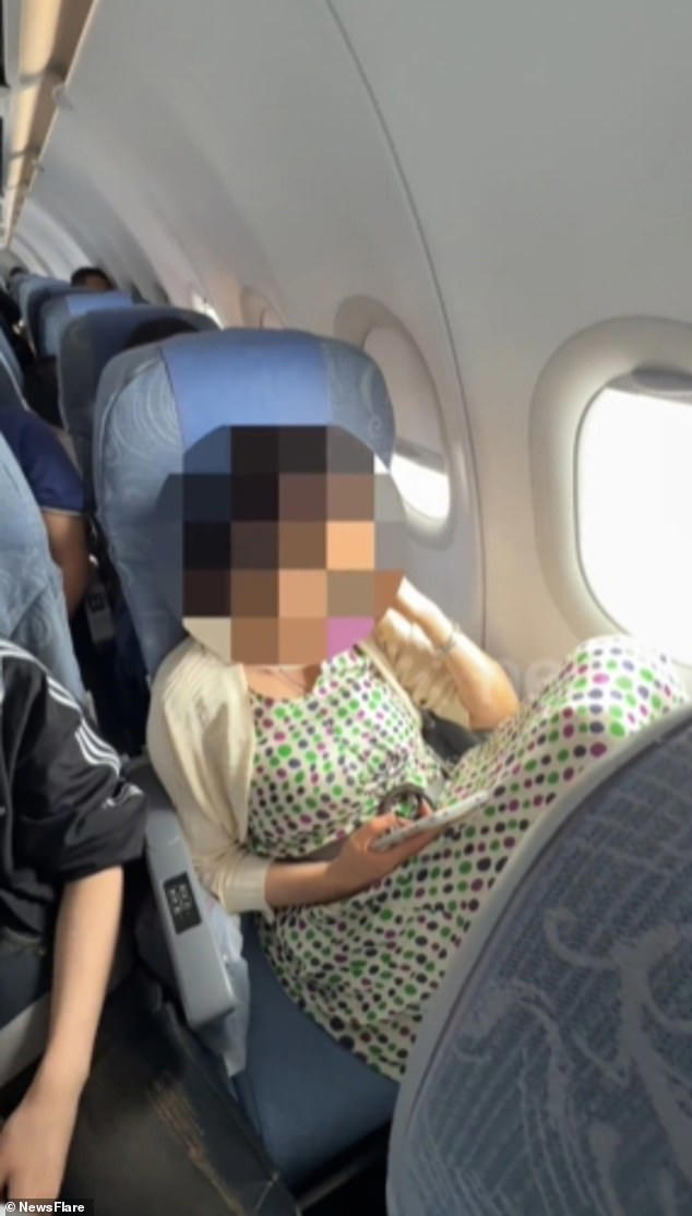 Air rage passenger rests her feet on the seat in front after fellow ...