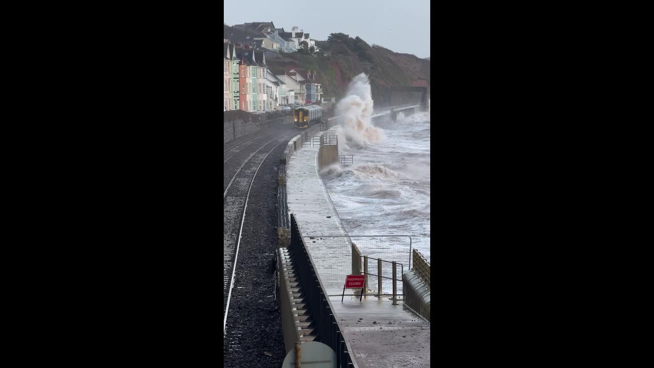 Storm Chandra: Huge waves crash over seawall and over passing trains in ...