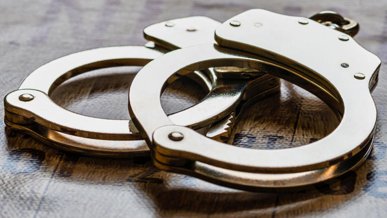 Standoff ends when fugitive falls from attic into motel room, police say