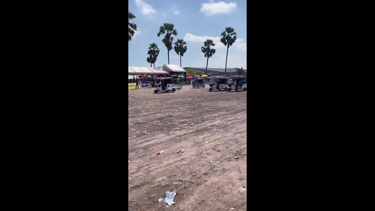 Dozens of tuk-tuks race across off-road track in Cambodia