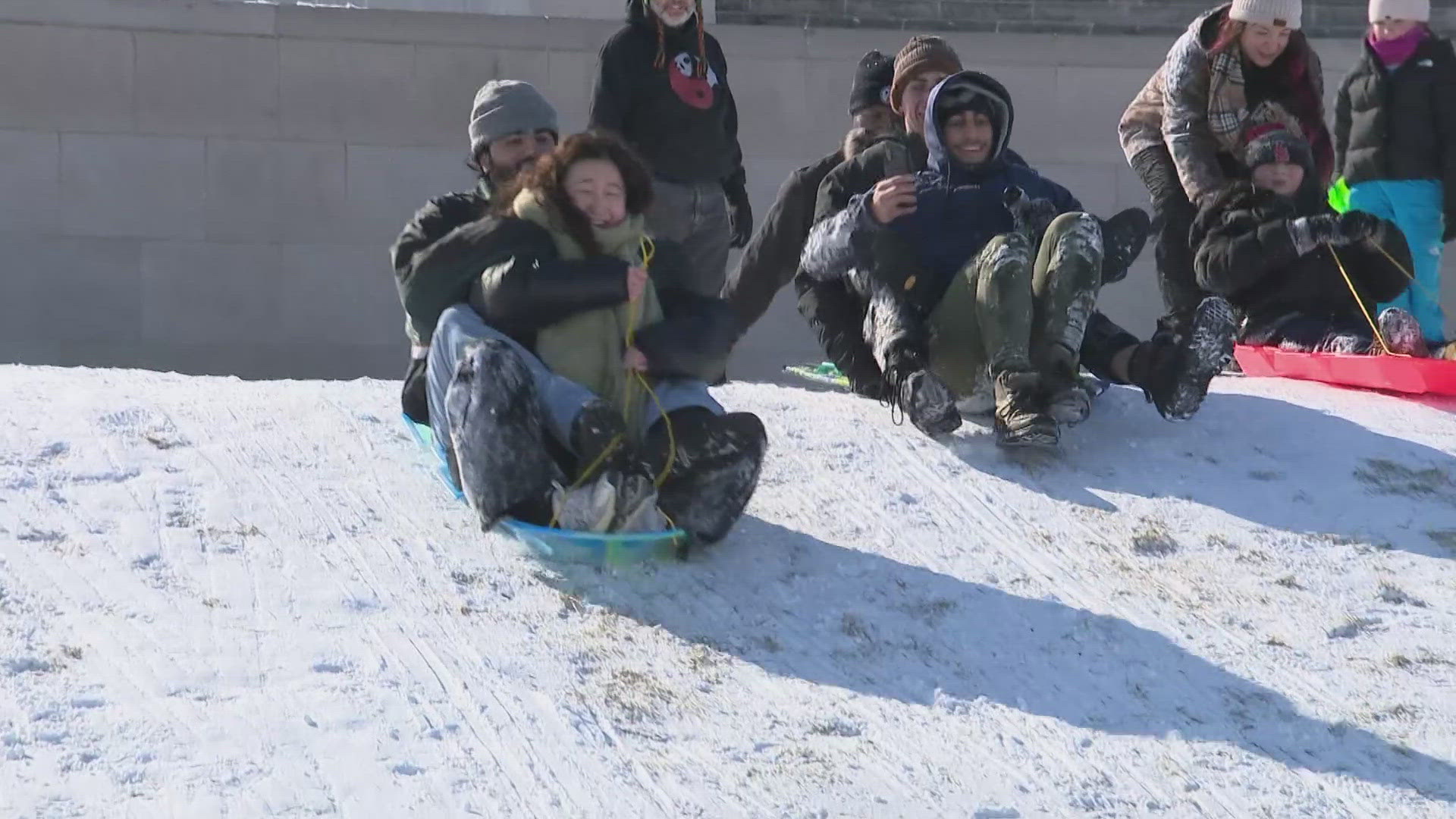 Dozens brave the cold to sled down Art Hill