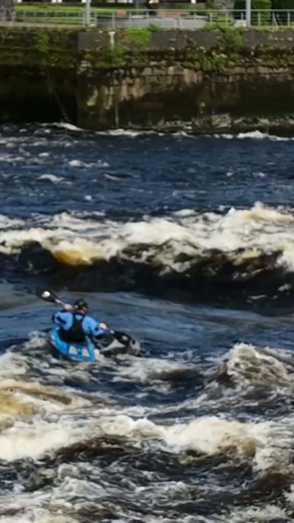 Surfing powerful river rapids in my kayak