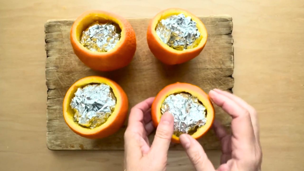 She stuffs silver foil into orange peels for this genius window idea!