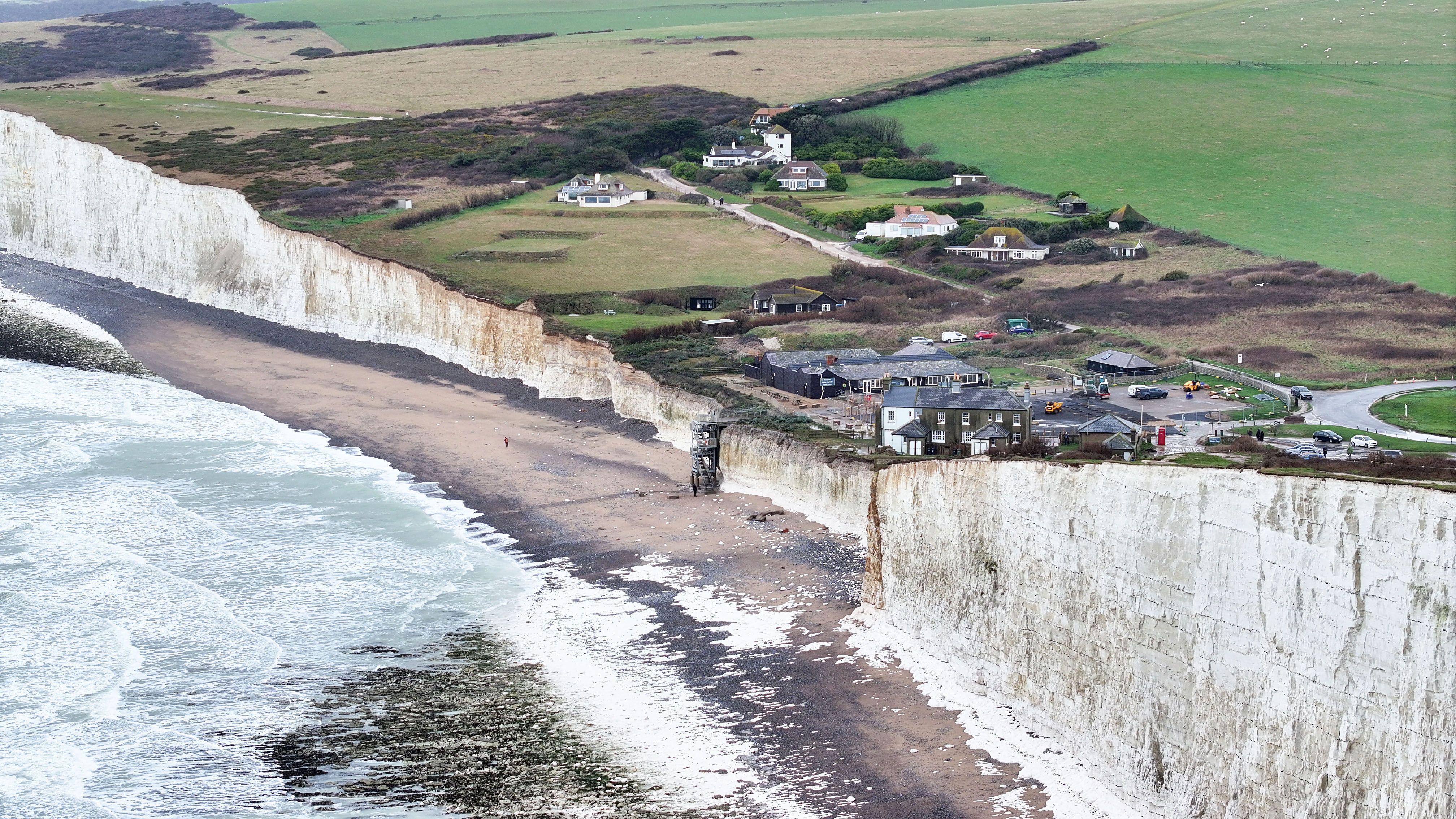 Families roped up cliff after getting stuck on beach