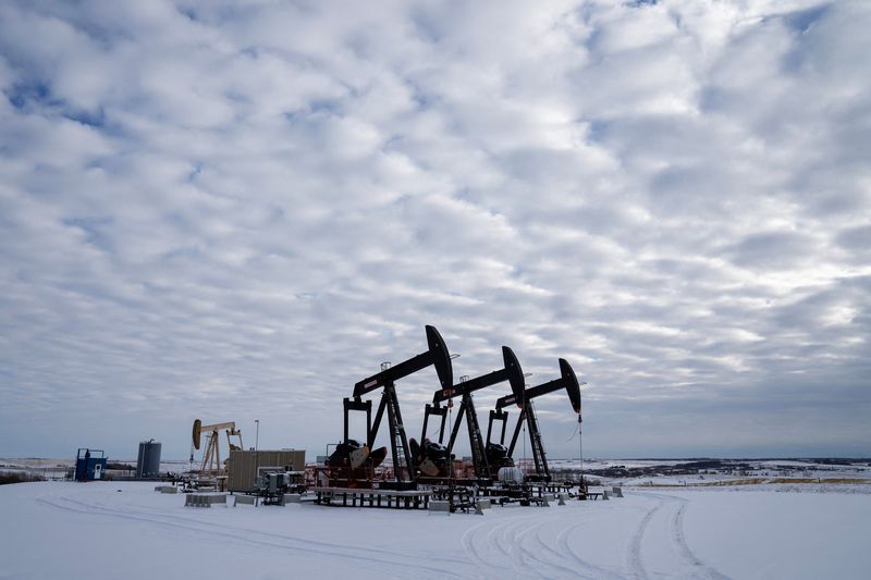 Oil prices hover around four-month high, buoyed by weak dollar and outages