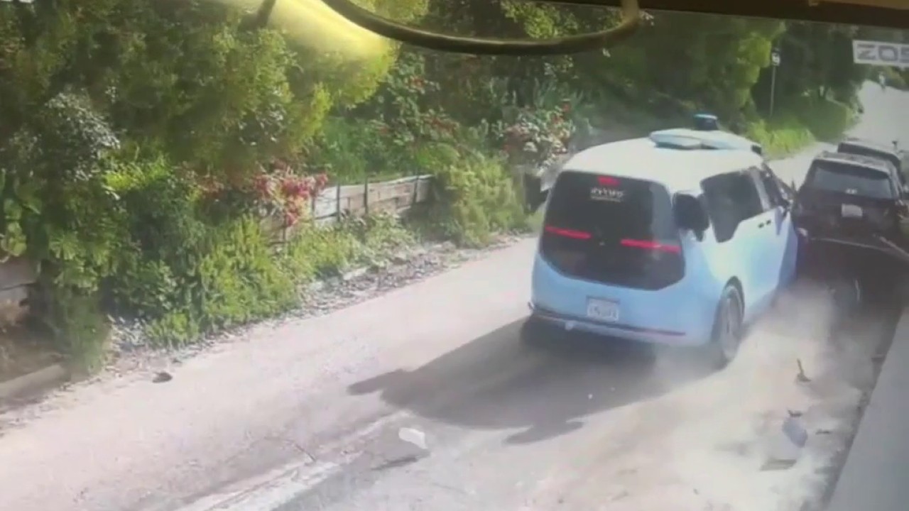 Waymo crashes into parked cars