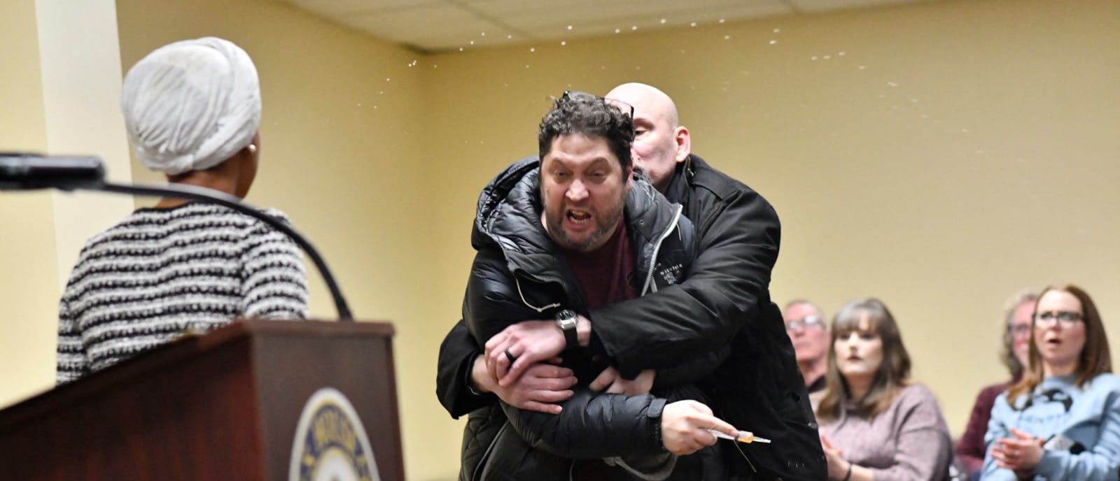 Man sprays Ilhan Omar with mystery substance at Minneapolis town hall