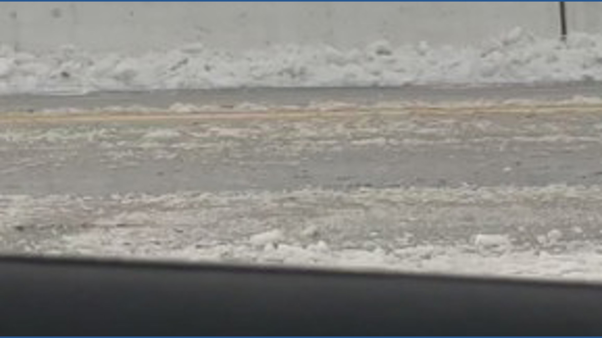 Plow trucks seen driving down I-14 plowing ice