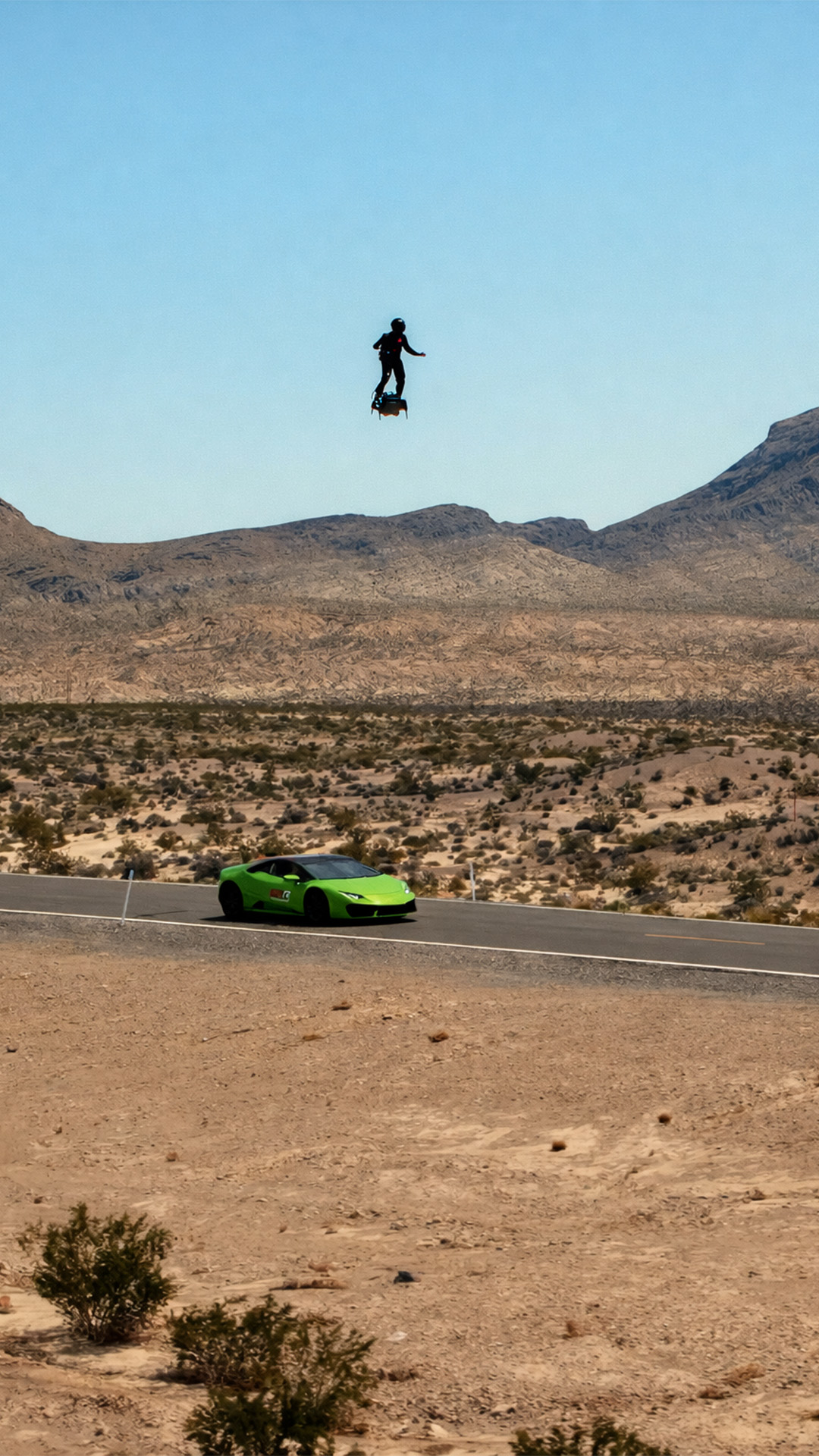 Man vs supercar filming a flyboard stunt against a Lamborghini