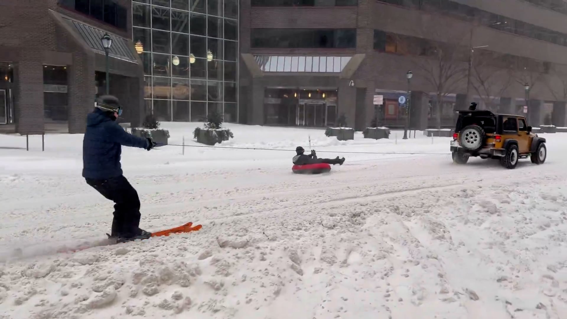 Skier hitches ride behind moving car in snowy Philly during Storm Fern