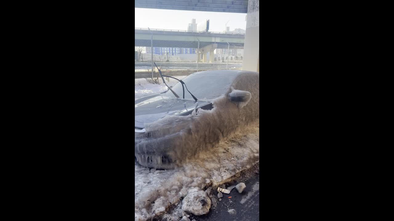 Car encased in thick layer of ice after water pipe bursts during winter ...
