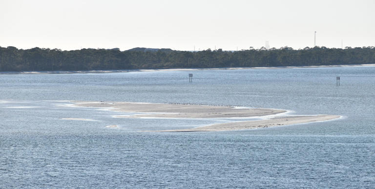 Low water reveals Crab Island; leaves boats on dry land around Destin