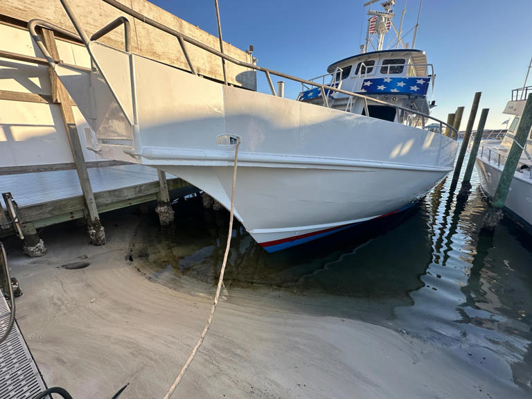 Low water reveals Crab Island; leaves boats on dry land around Destin