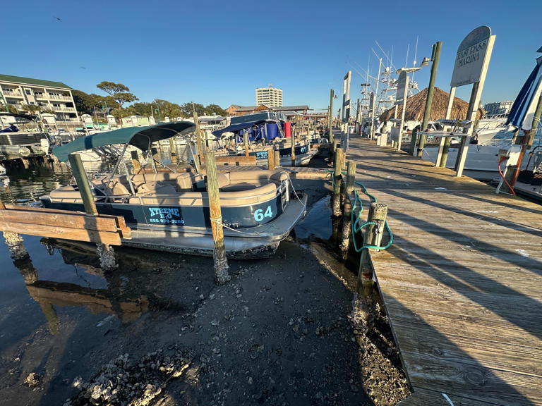 Low water reveals Crab Island; leaves boats on dry land around Destin